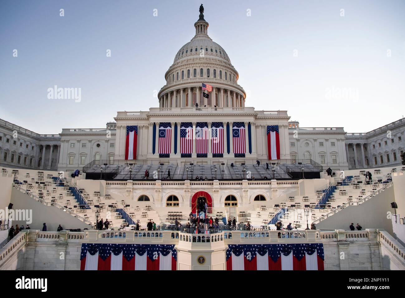 The sun rises behind the U.S. Capitol as preparations are made prior to ...