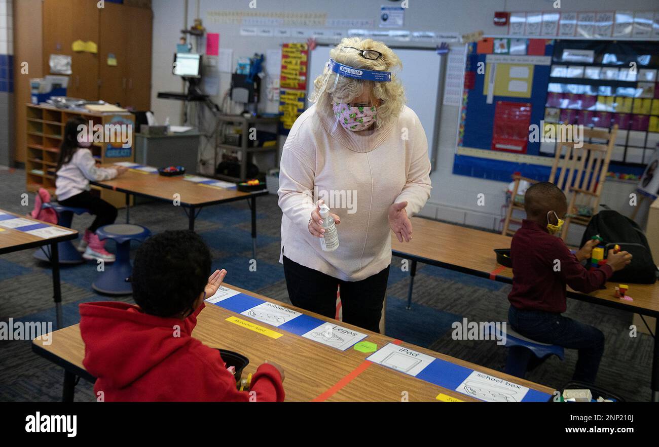 Kindergarten teacher Sherri Shober doles out hand sanitizer to students Tuesday, Jan. 19, 2021 ...
