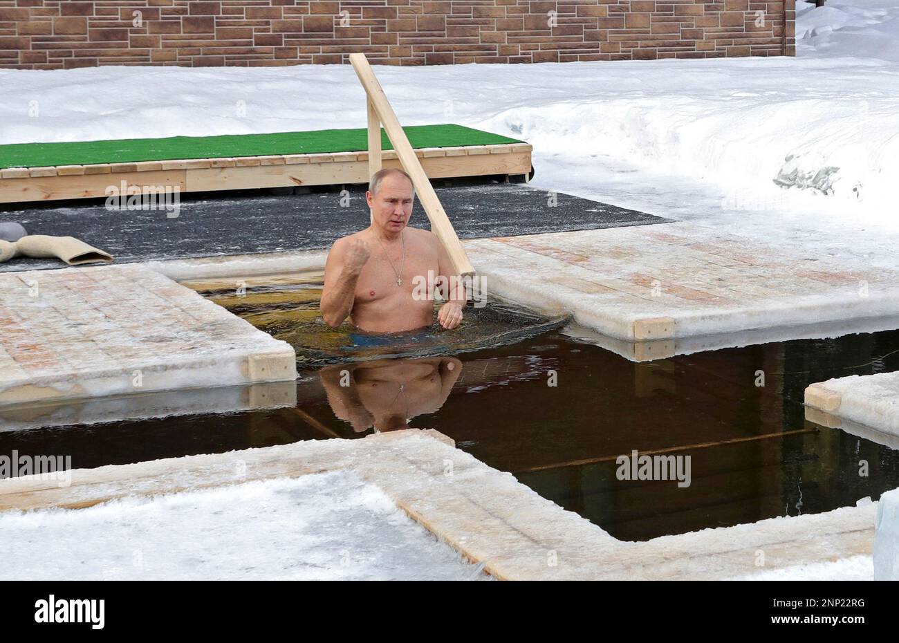 Russian President Vladimir Putin crosses himself while bathing in the ...