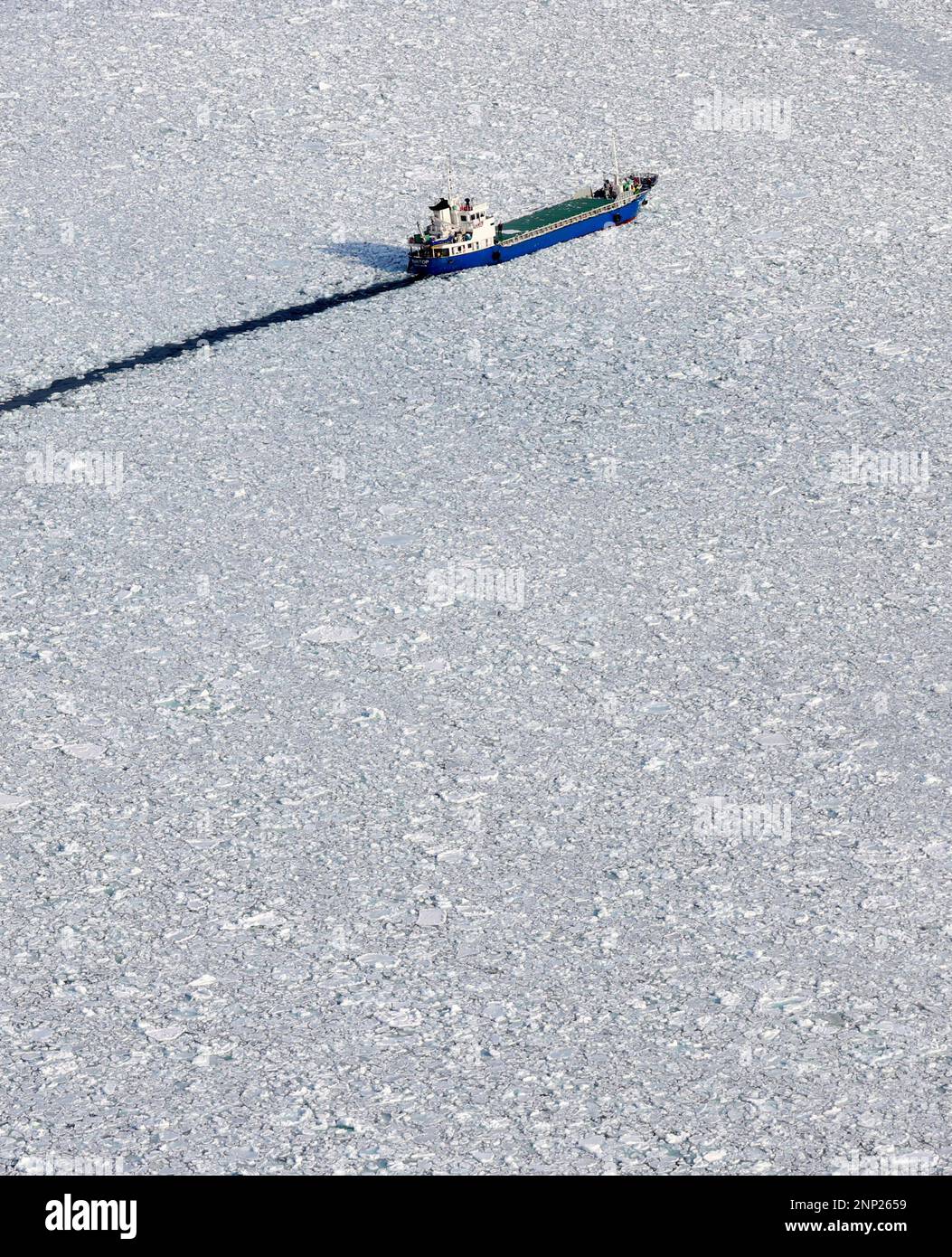 An aerial photo shows a tanker advancing in a sheet of drifting ice off ...