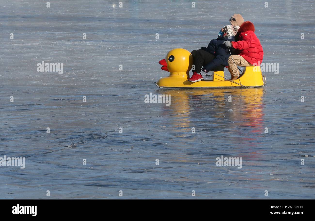 People wearing masks enjoy skating at Shichahai Ice Link, also known as ...