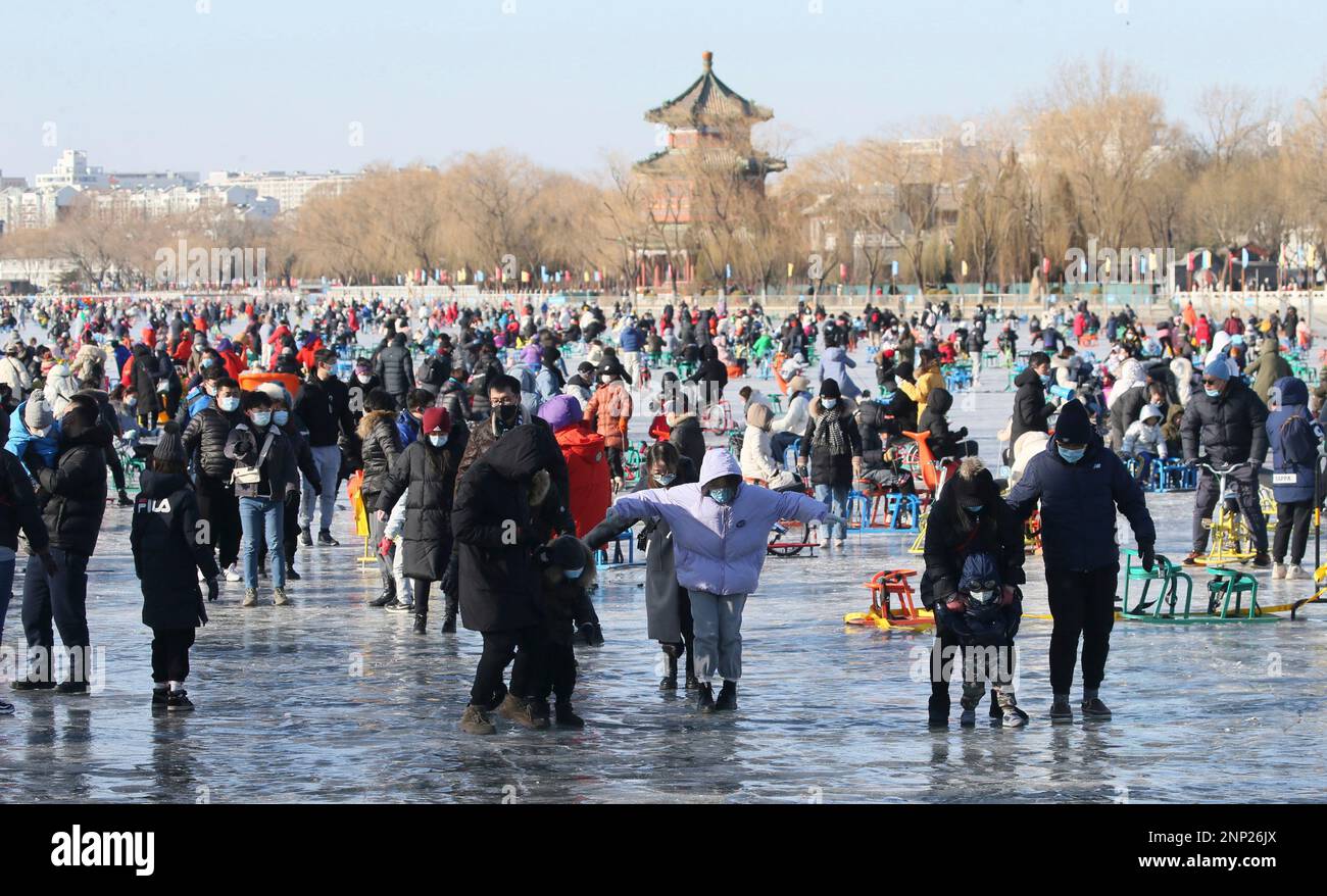 People wearing masks enjoy skating at Shichahai Ice Link, also known as ...