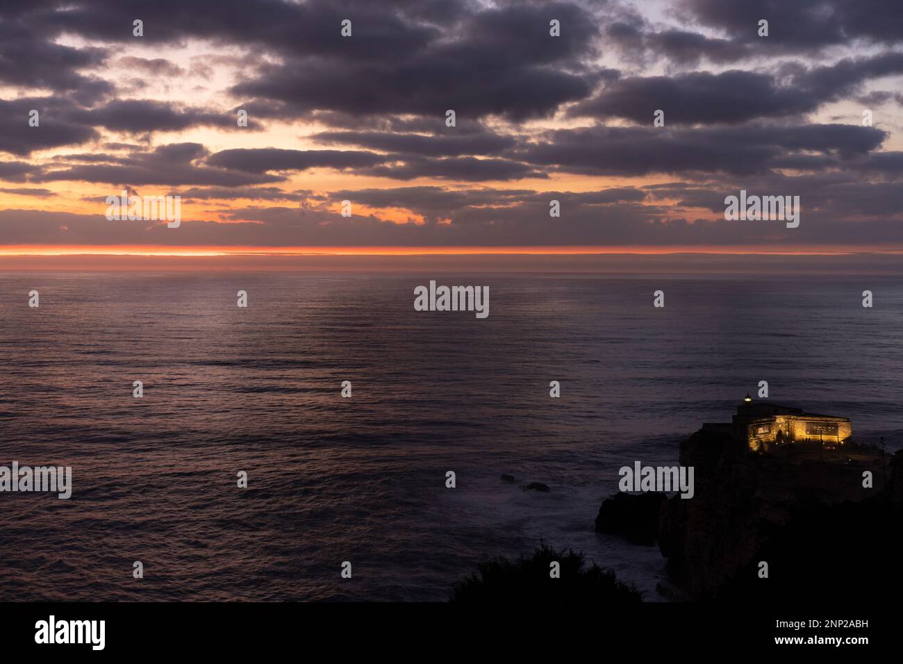 Illuminated Penedo D Saudade Lighthouse at night, Portugal Stock Photo ...