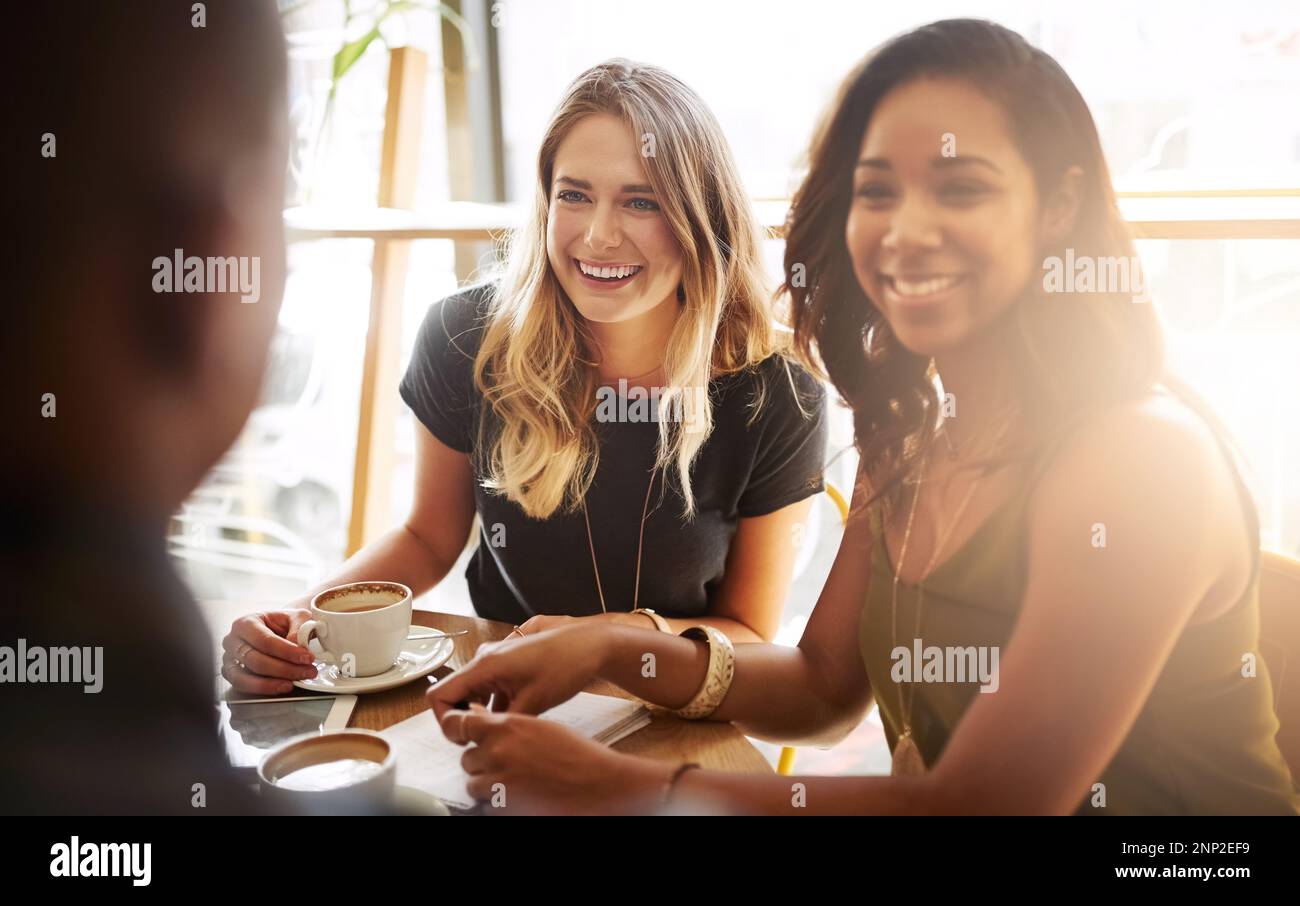 Coffee brings people together. a group of friends catching up over ...