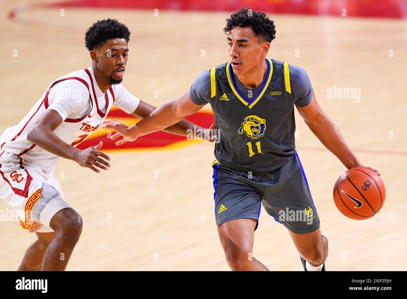 LOS ANGELES, CA - JANUARY 12: UC Riverside guard Flynn Cameron (11) drives past USC Trojans ...