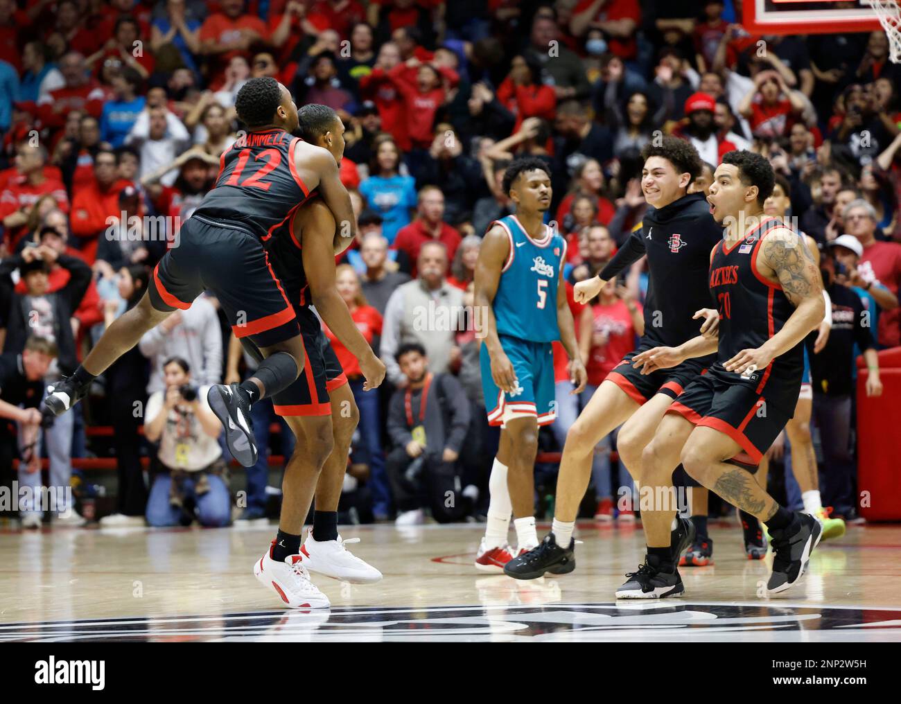 San Diego State's Darrion Trammell (12) jumps onto Lamont Butler after ...