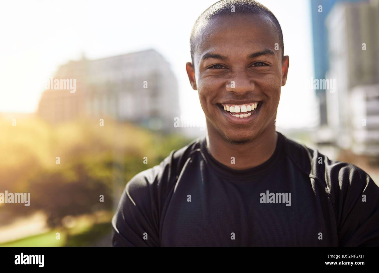 Staying fit in the urban jungle. Portrait of a sporty young man ...