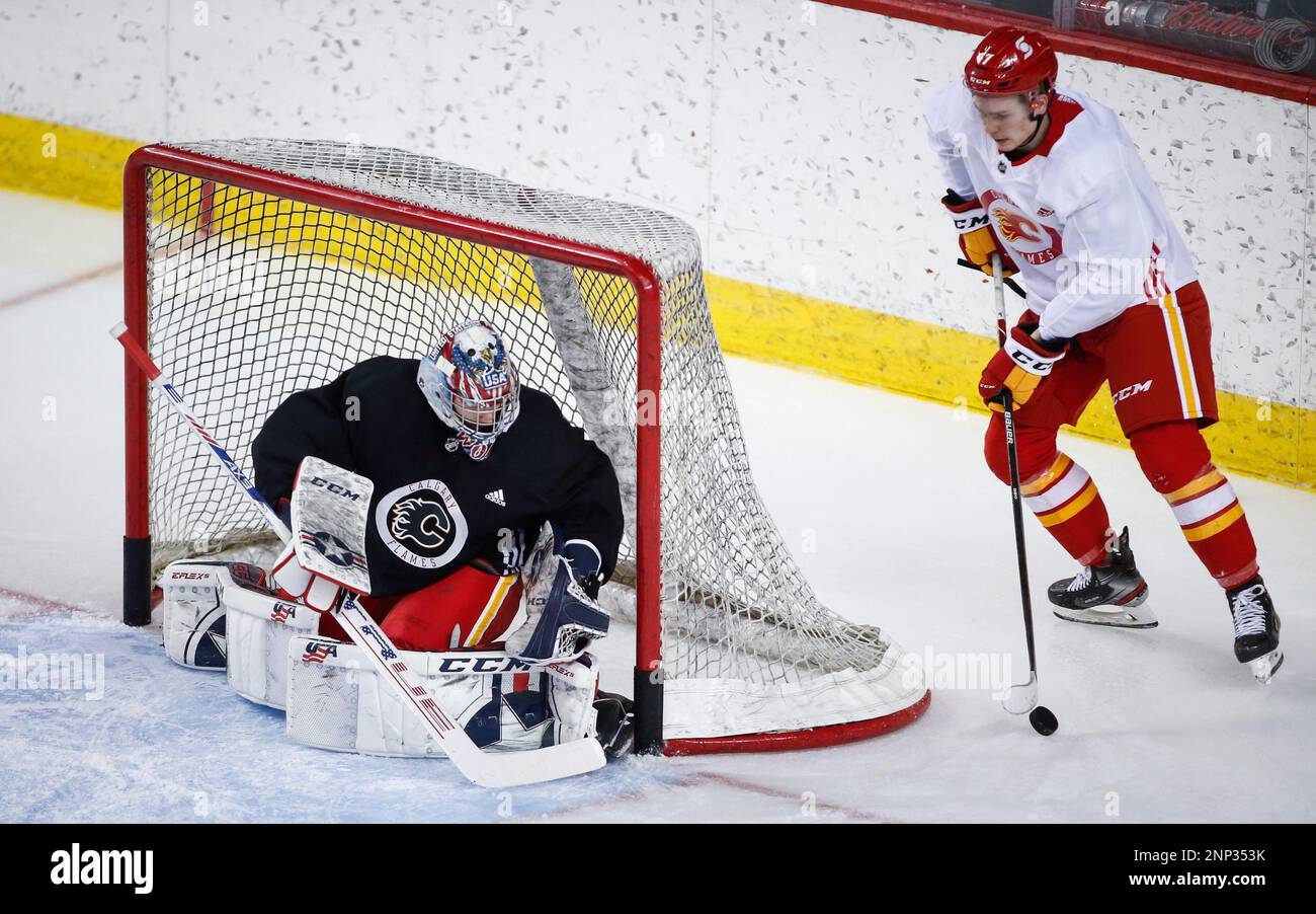 Calgary Flames' Connor Zary, right, tries to get the puck past goalie ...