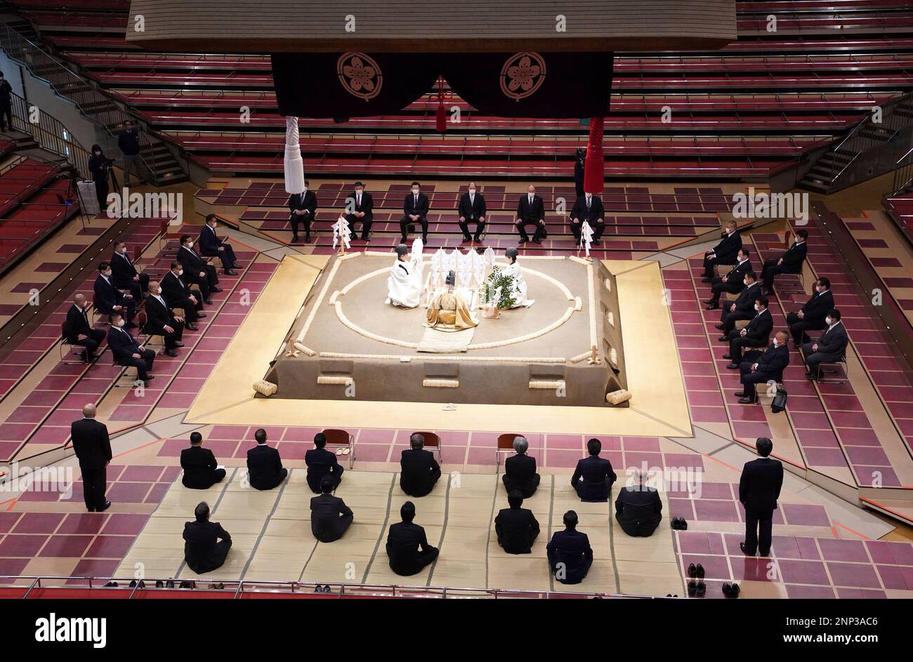 Shinto priests purify a dohyo, sumo ring one day prior to the New Year ...