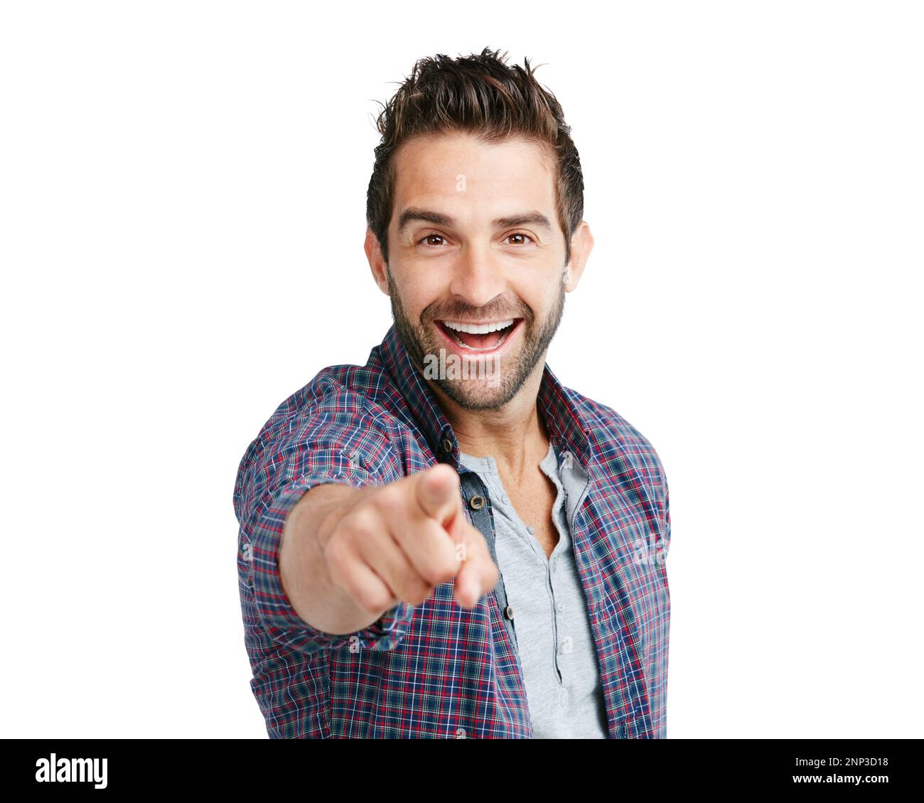 Dont forget to smile. Studio shot of a young man pointing against a ...