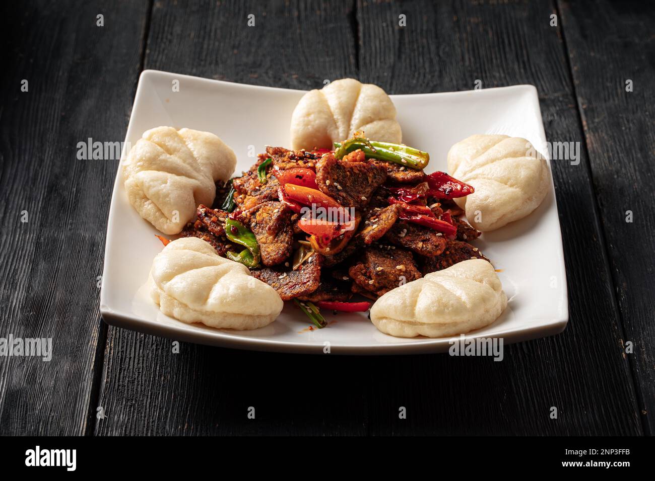 Portion of asian cooked beef with steamed buns Stock Photo - Alamy