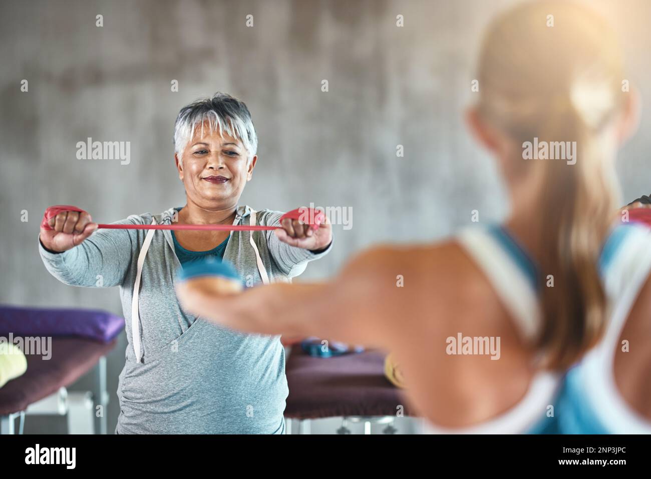 Wellness is ageless. a senior woman using resistance bands with the ...