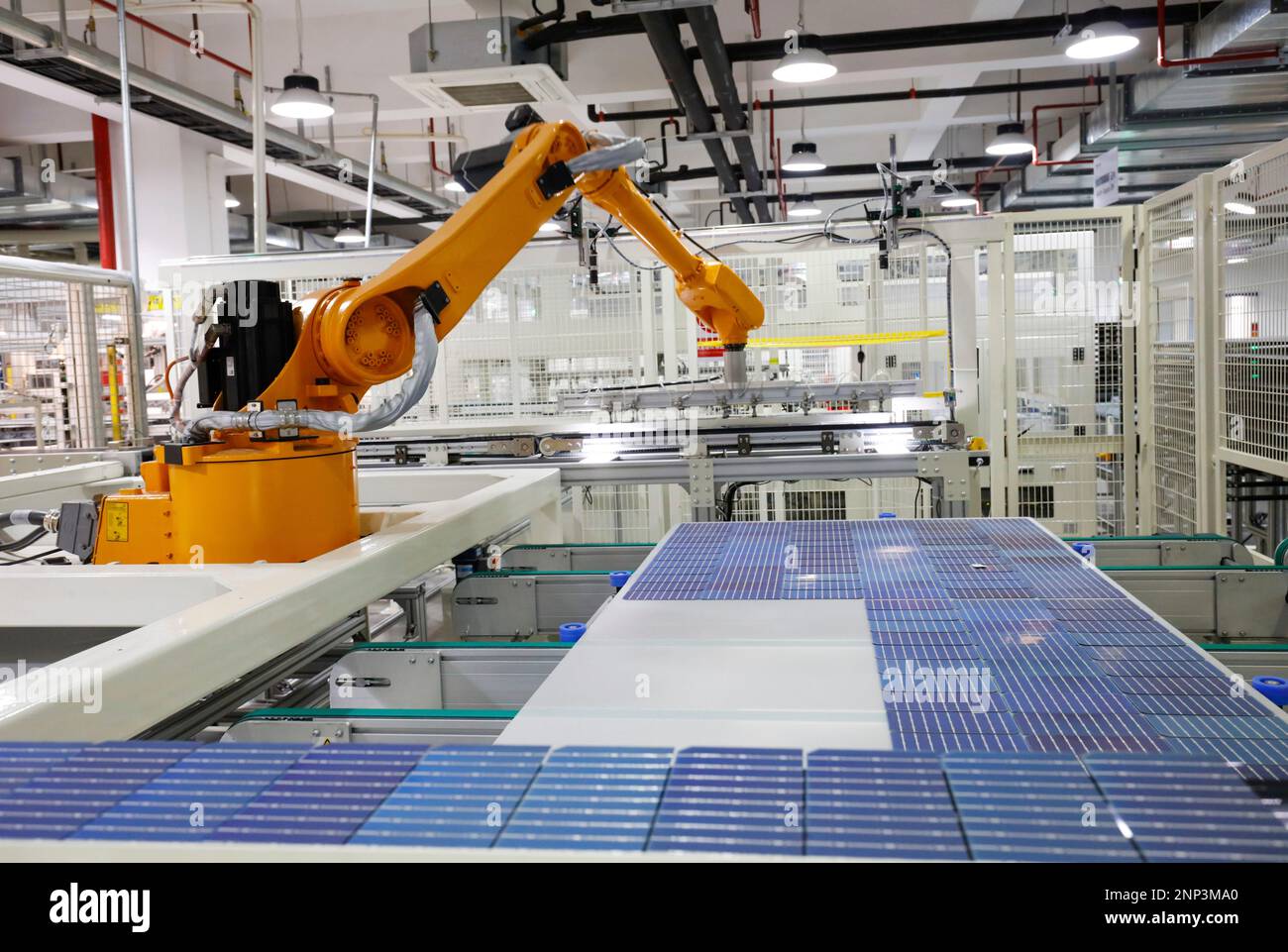 A robot works in a factory of solar panel and parts in Jiujiangu in ...