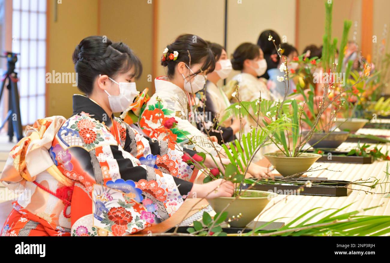 Ikenobo-style ikebana apprentices wearing masks attend the 'Hatsuike ...