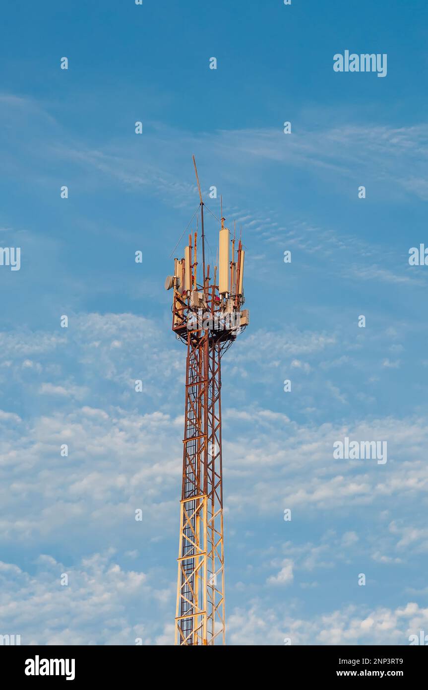 Cell tower of mobile communication with antennas transmitters against the background of clear ...