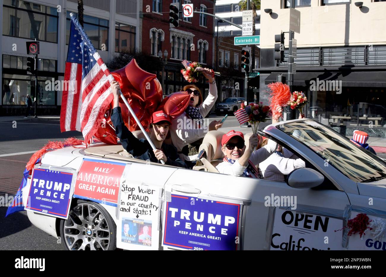 Trump supporters parade along the Rose Parade route on Colorado Blvd in ...