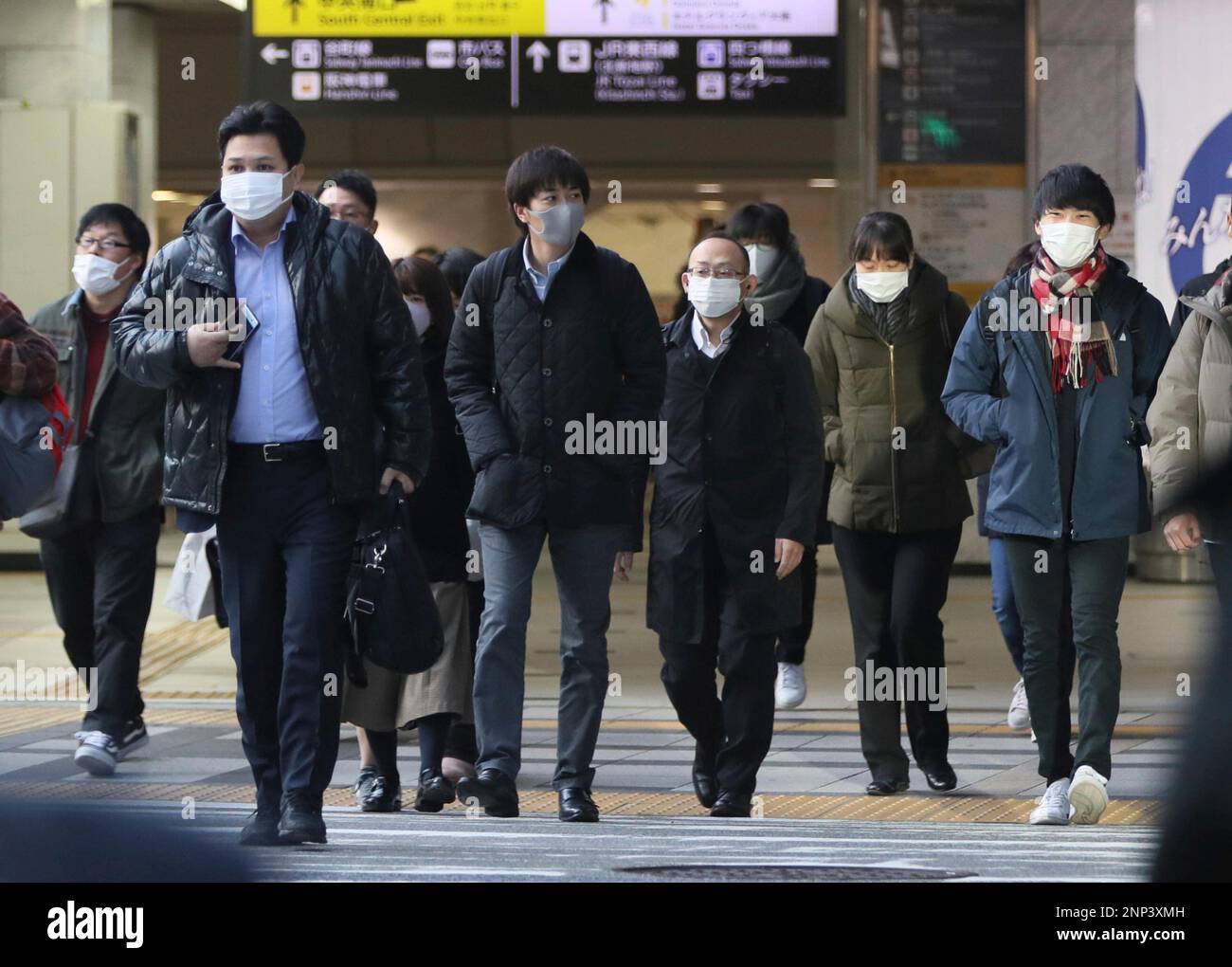 Commuters wearing masks are seen near Osaka station in Oaska on Jan. 4 ...