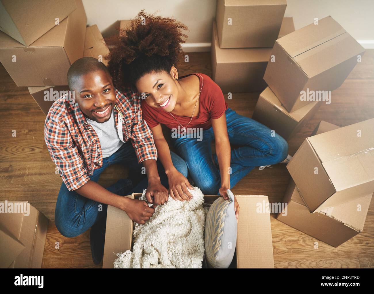 Unpacking is a mission well conquer together. Portrait of a young ...