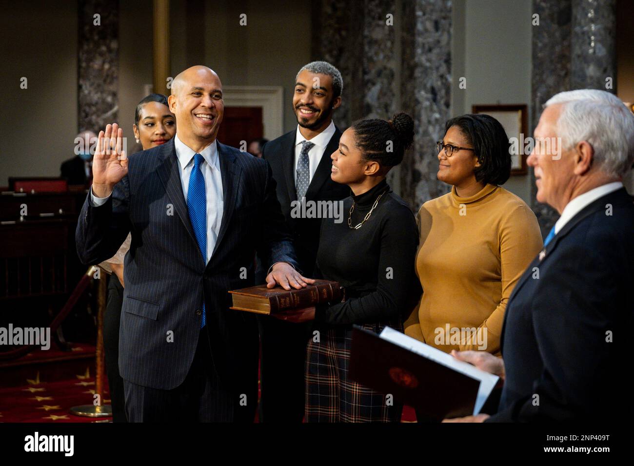 Sen. Cory Booker, D-N.J., raises his hand to take the oath of office ...