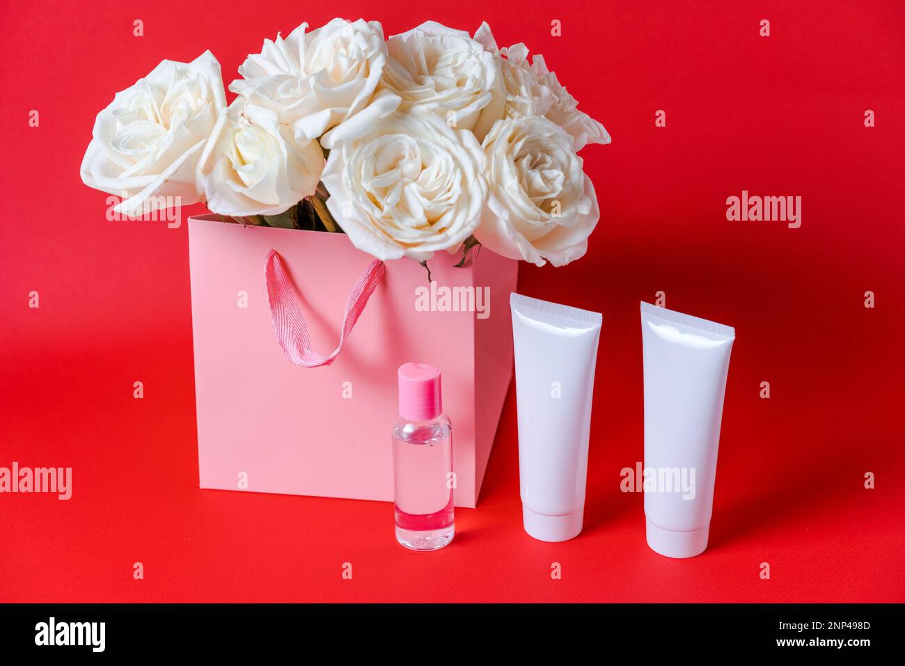 Natural white rose bouquet. Empty white hair shampoo tube with serum ...