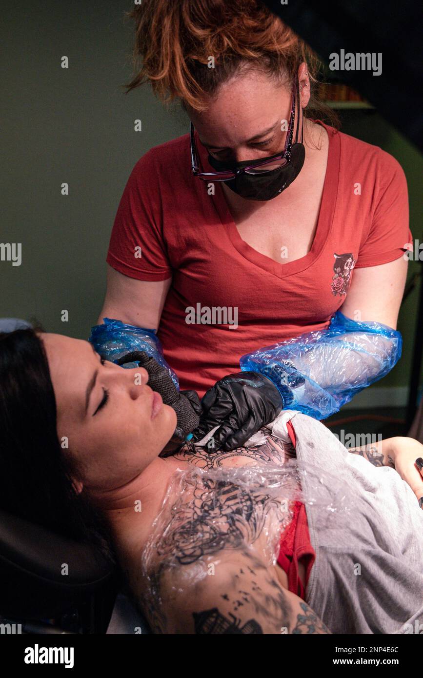 Tattoo artist Kristy Reeves tattoos Jami Ryan's collarbone at Heart and ...