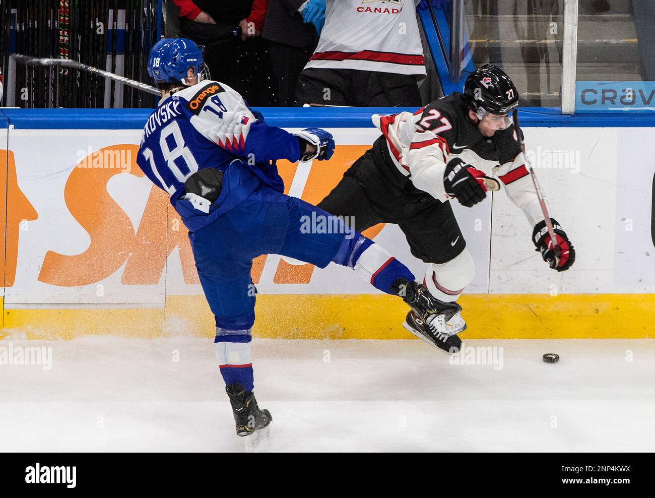 Canada's Justin Barron (27) is checked by Slovakia's Juraj Slafkovsky ...