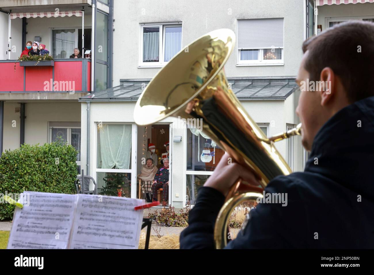Florian Linse plays his tuba for his great-grandmother, outside an ...