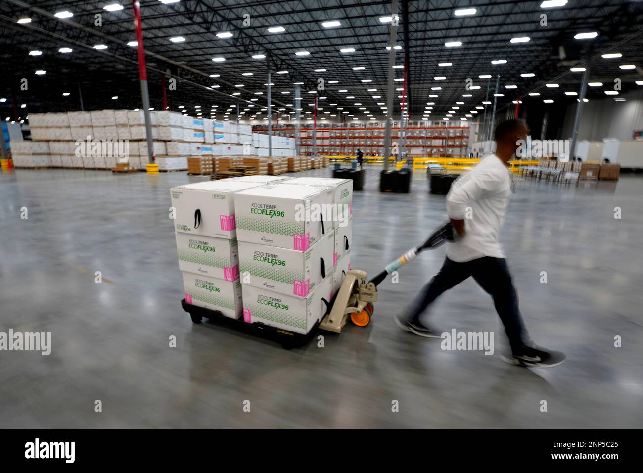 Boxes containing the Moderna COVID-19 vaccine are moved to the loading ...