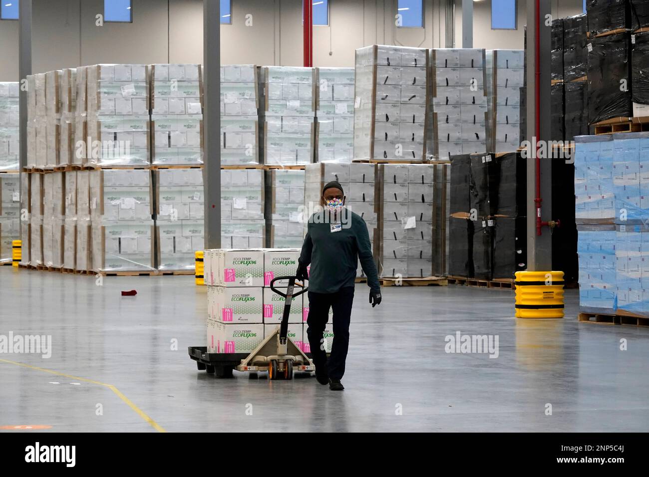 Boxes containing the Moderna COVID-19 vaccine are moved to the loading ...