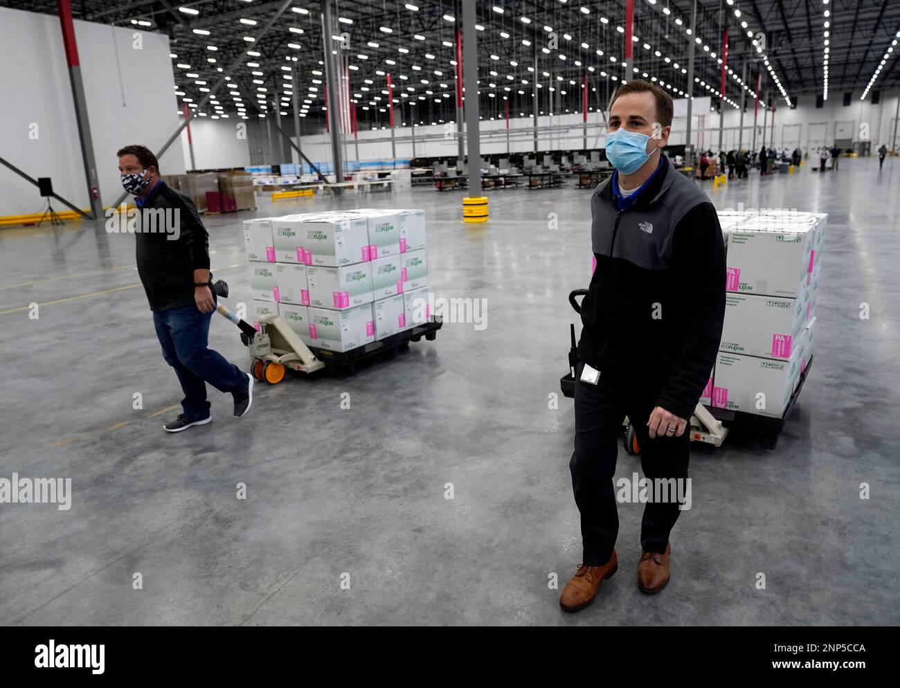 Boxes containing the Moderna COVID-19 vaccine are moved to the loading ...