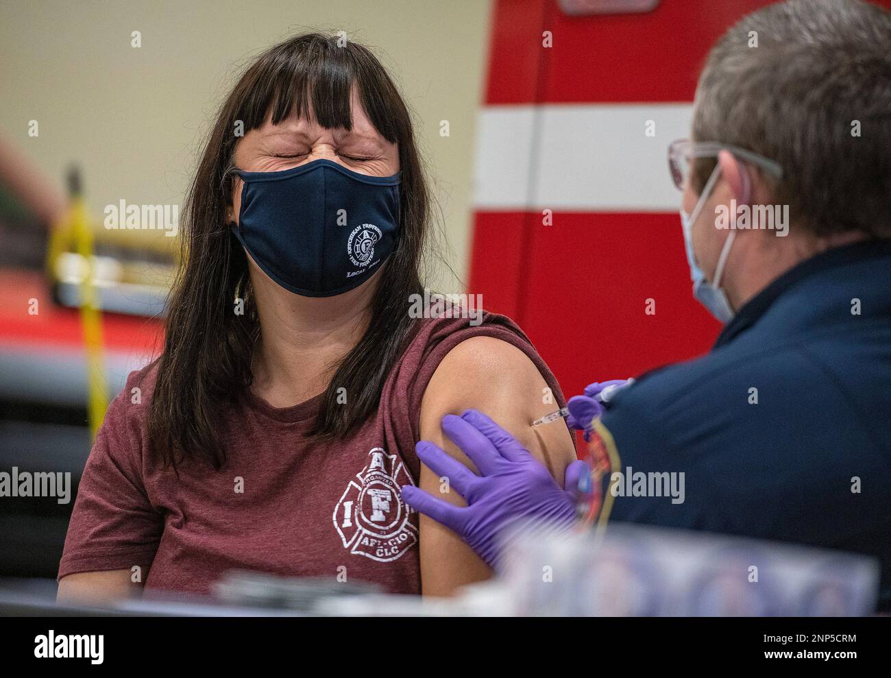 Fire Marshal Gretchen O'Sullivan receives a COVID-19 vaccine shot from ...