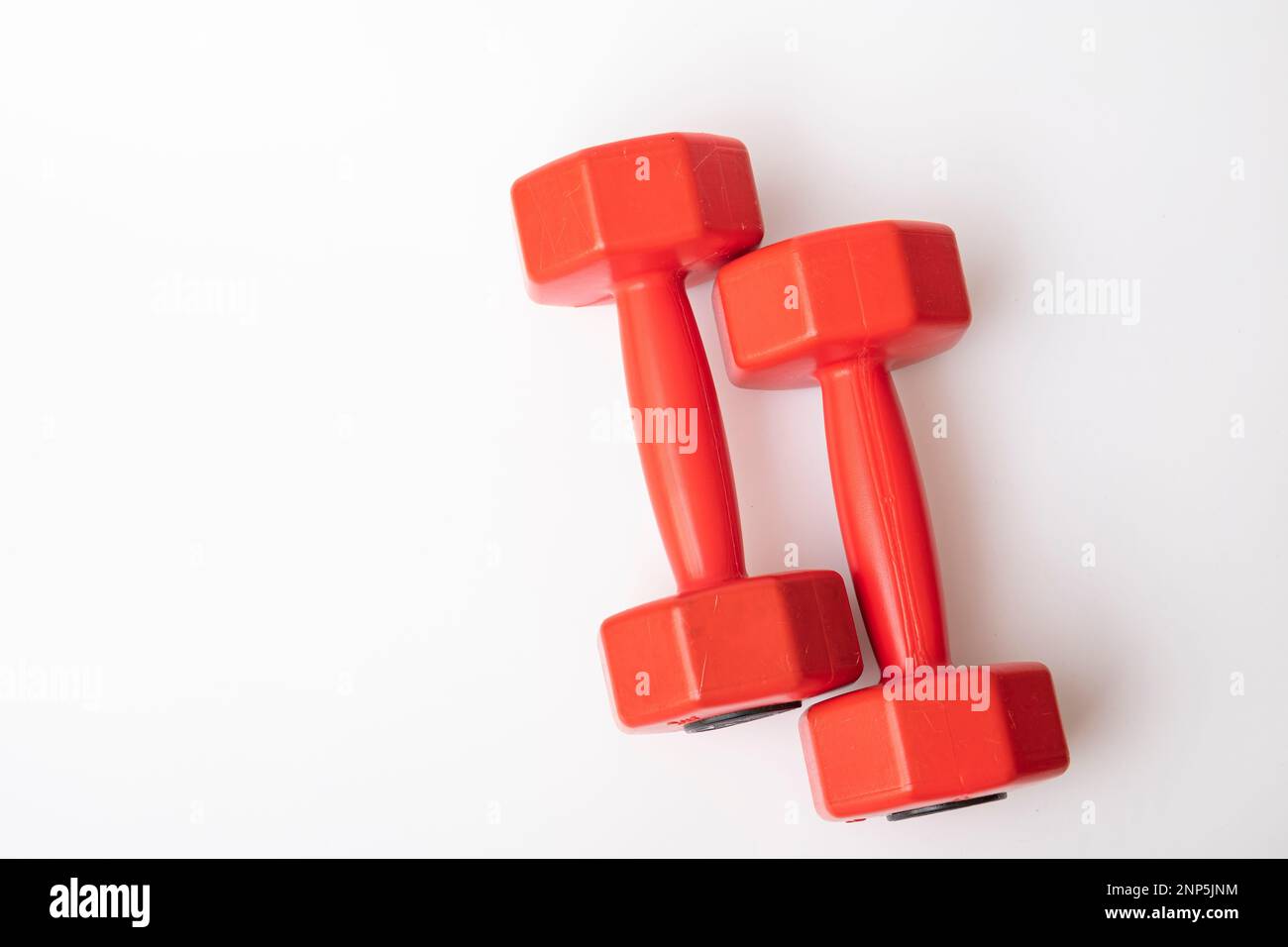 Red dumbbell for fitness isolated on white background Stock Photo - Alamy