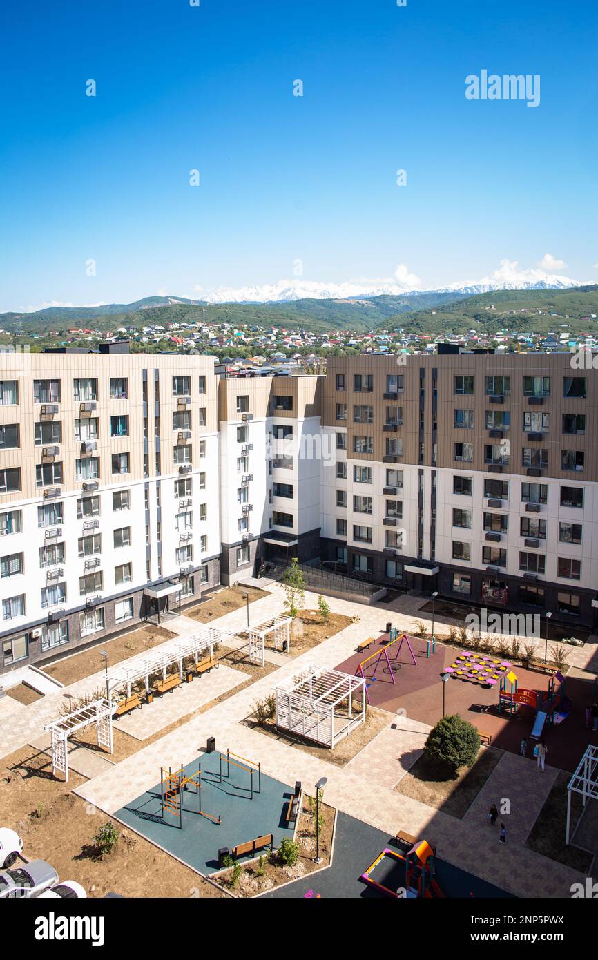 top view of the courtyard of a multi-storey building with a playground ...