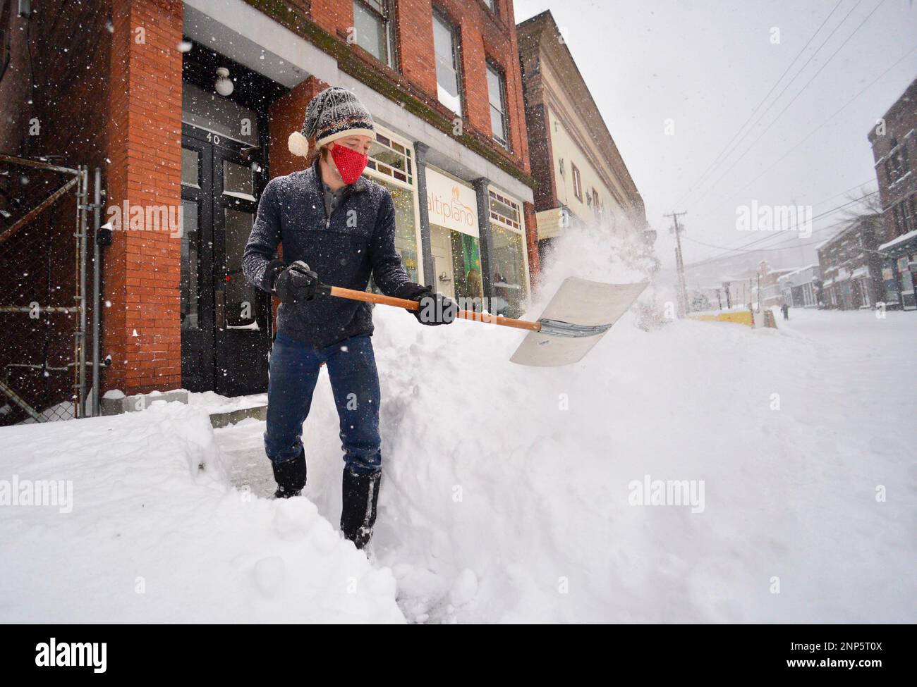 Don Houghton shovels the snow from a section of sidewalk on Elliot ...