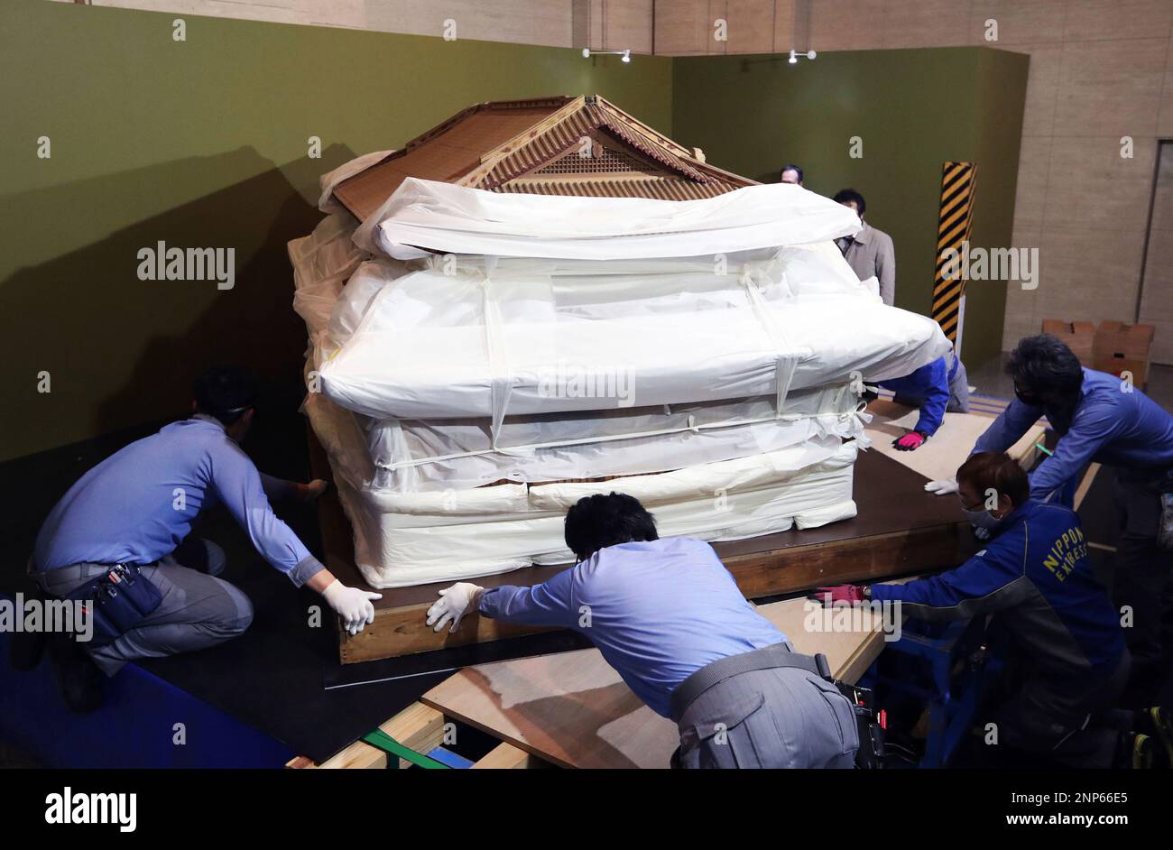 A model of Shuri Castle is brought into the Tokyo National Museum in ...