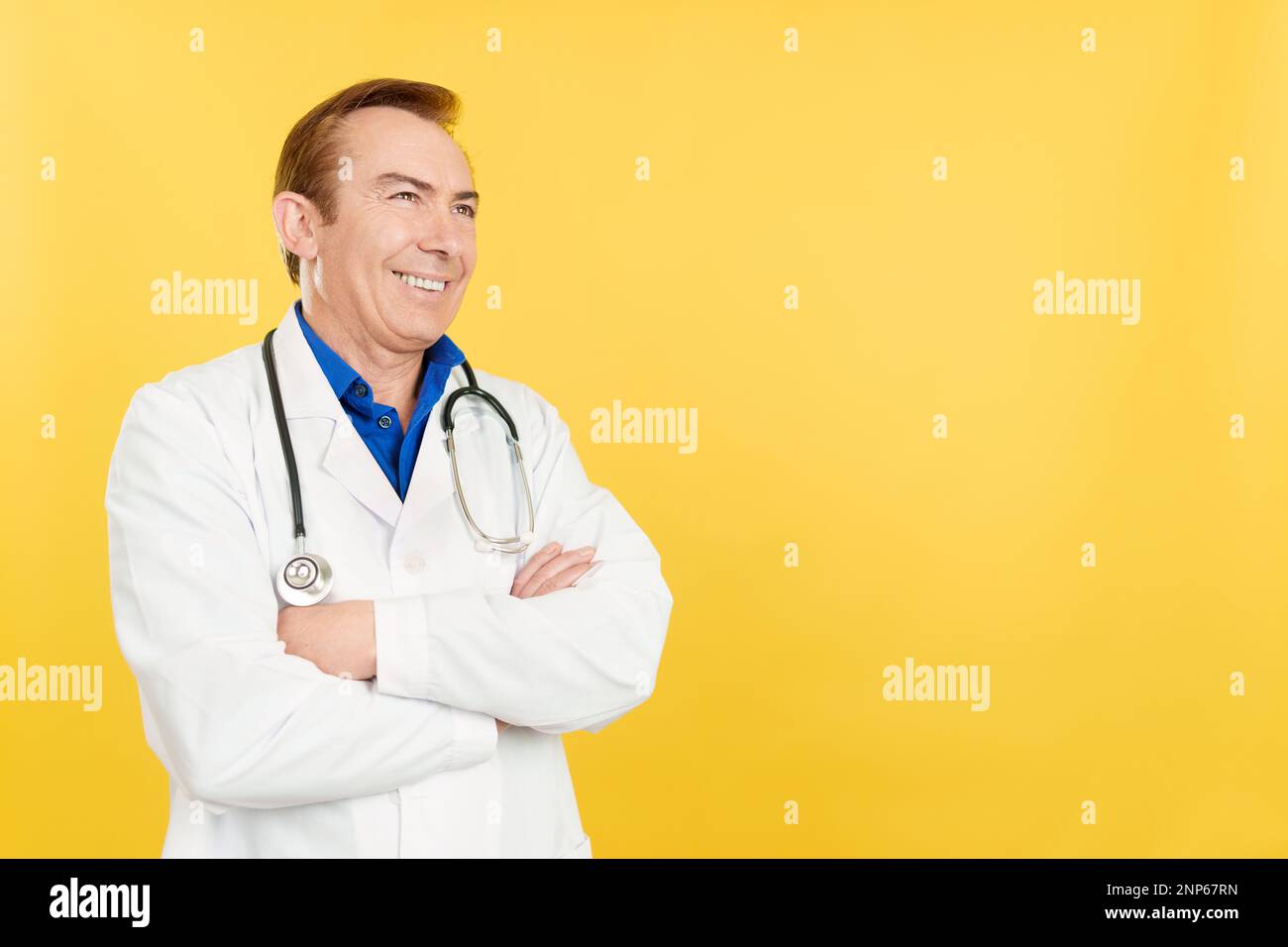 Mature doctor looking aside distracted with arms crossed Stock Photo ...