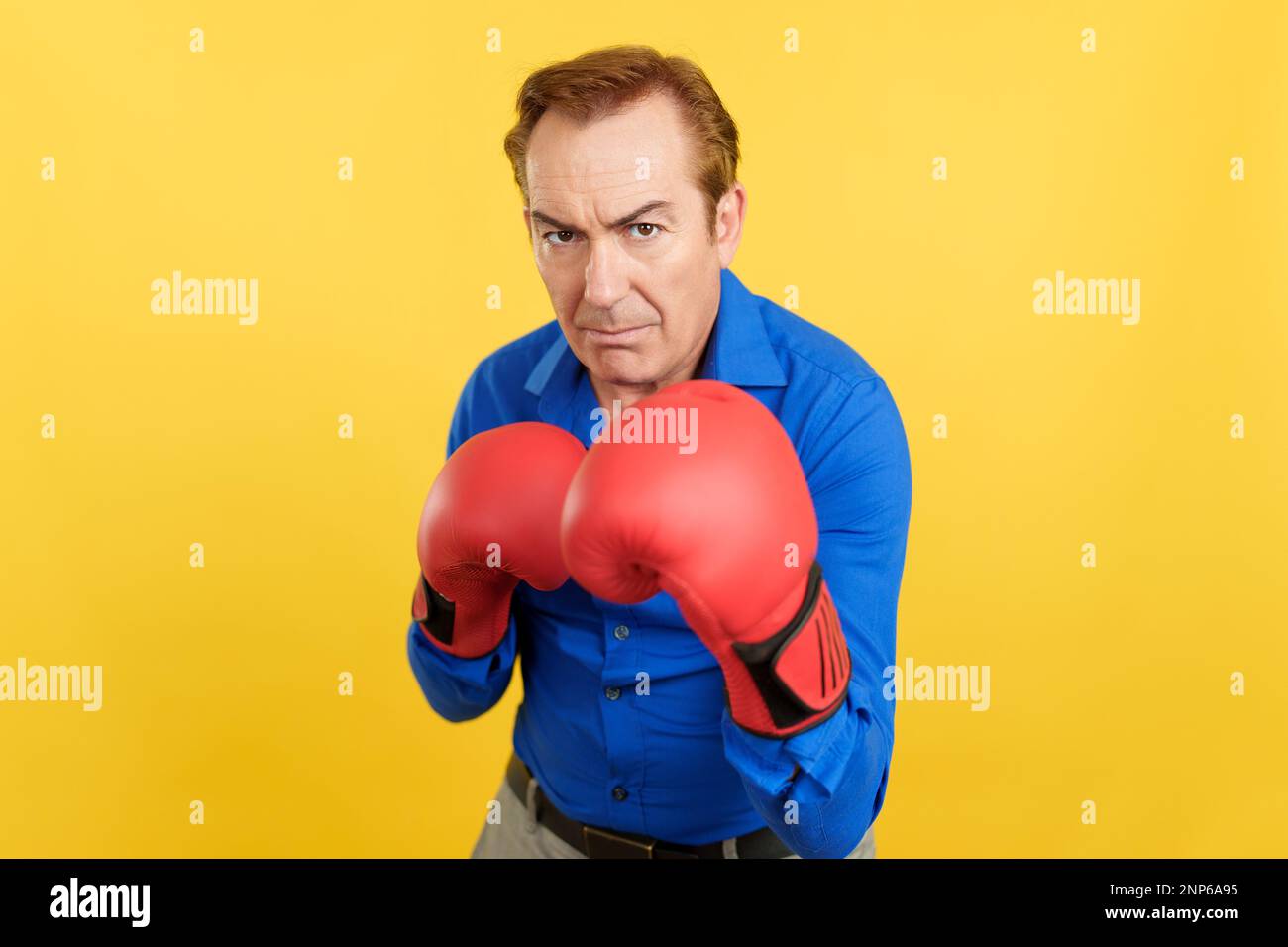 Mature man with boxing gloves in guard pose of boxing Stock Photo - Alamy