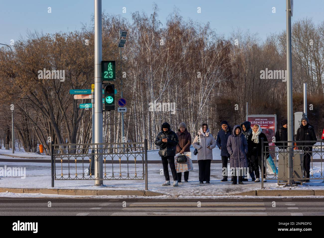 Astana, Kazakhstan - November 23, 2022: People stand at pedestrian ...