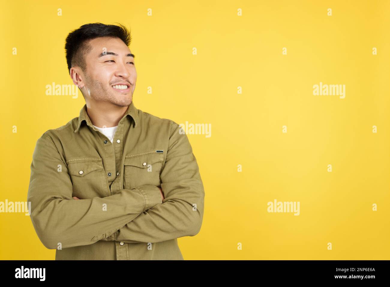 Chinese man smiling while looking to the side Stock Photo - Alamy