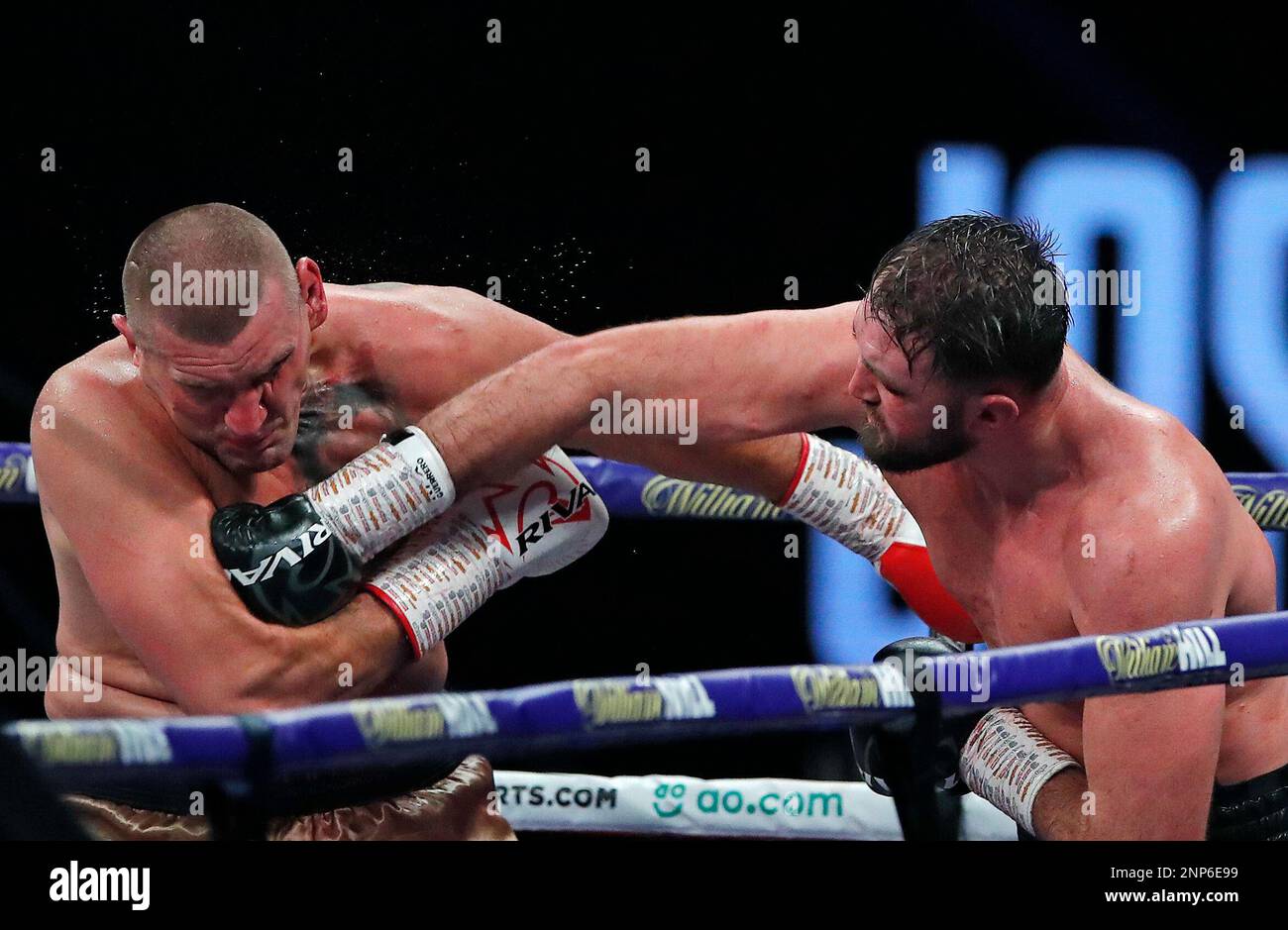 Britain's Hughie Fury, right, throws a punch at Poland's Mariusz Wach ...