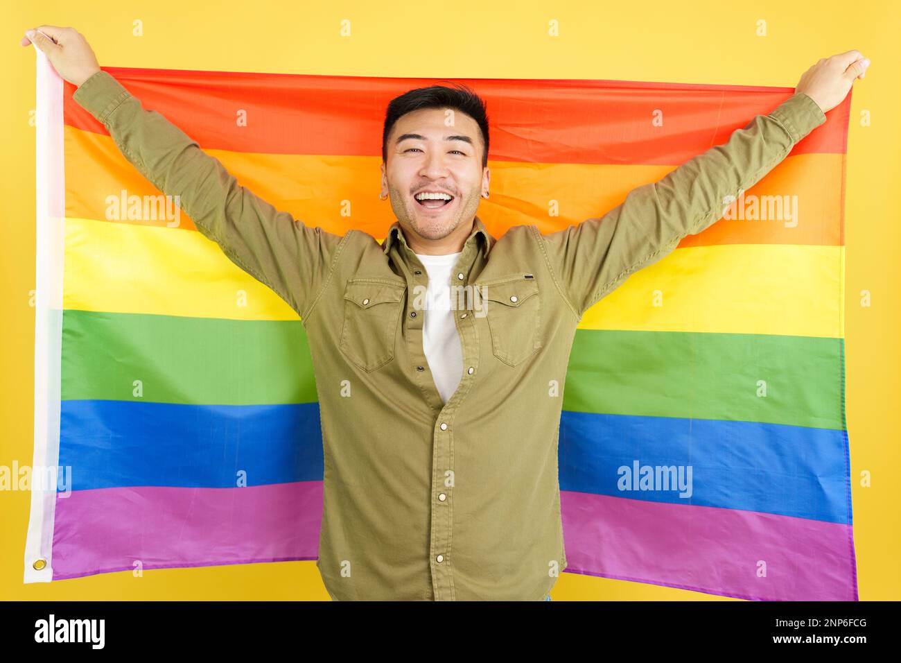 Happy chinese man raising a lgbt rainbow flag Stock Photo - Alamy