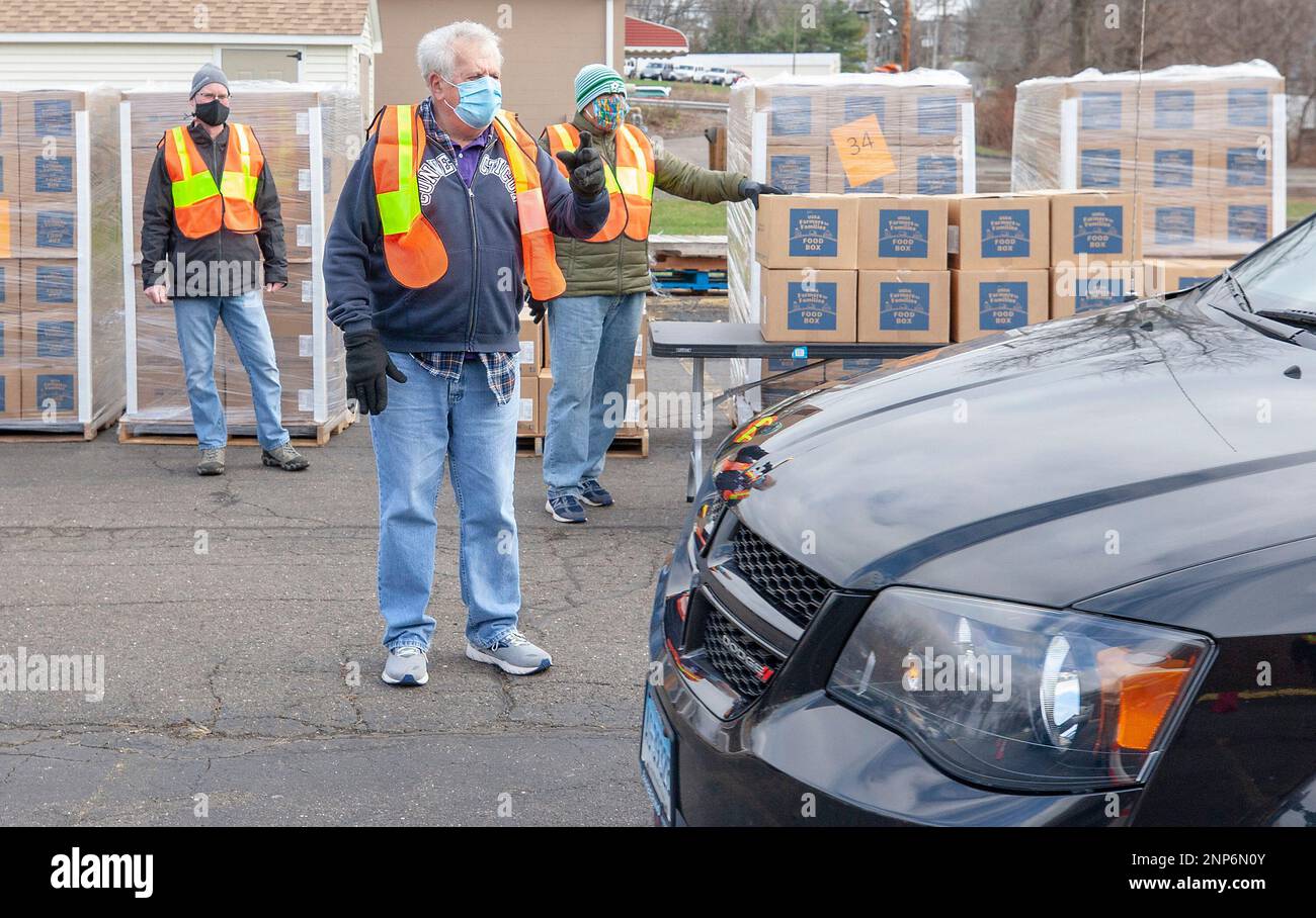 Master's Manna Board Director Bob McKenzie waves the next vehicle up as ...