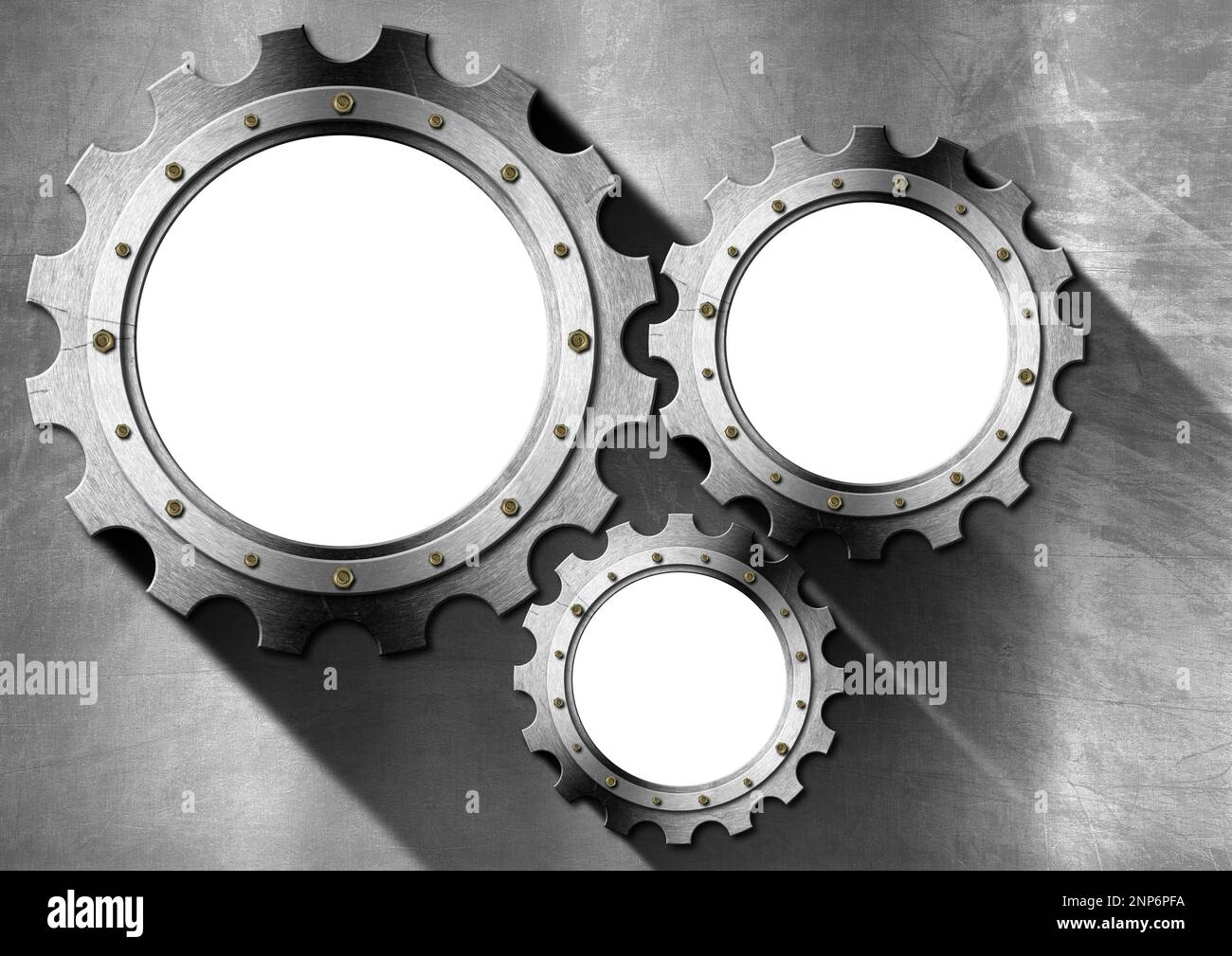 Group of three empty metal gears (cogwheels) on stainless metal ...
