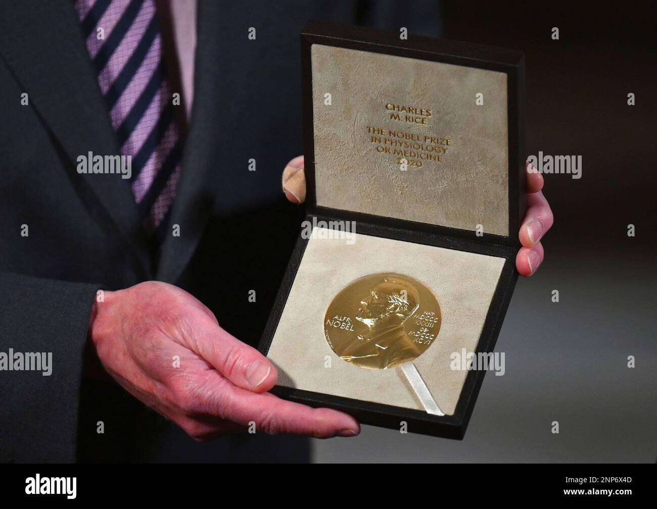 Charles M. Rice holds his Nobel prize medal in physiology or medicine ...