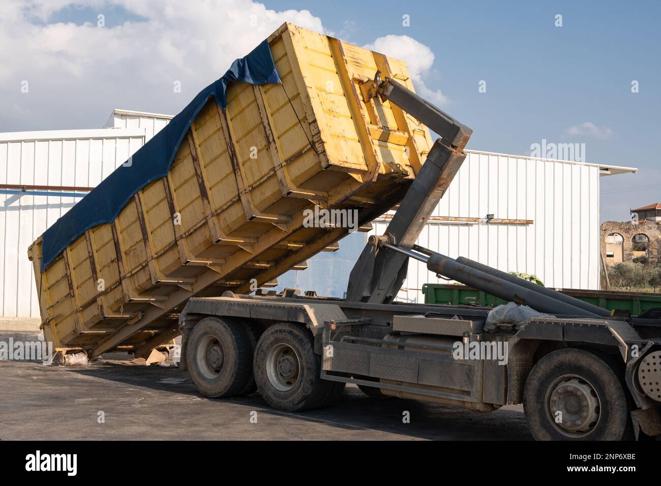 Truck loading waste in huge metal container, full recycling used ...