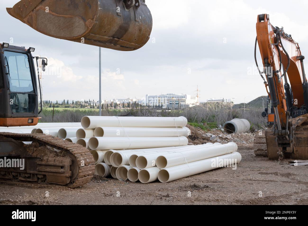 Plumbing. new PVC pipe heap, pile near the construction site for the ...