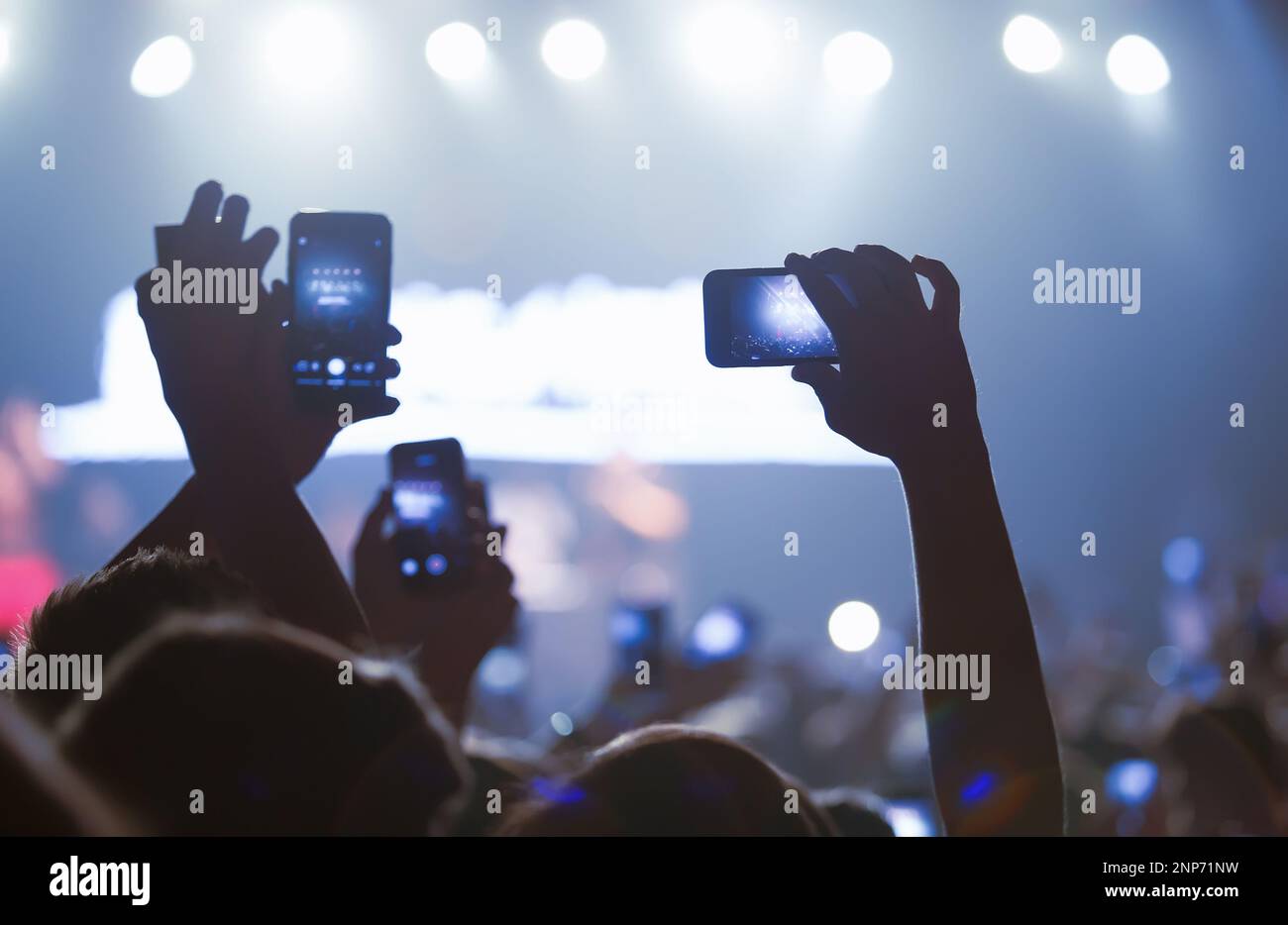 Concert crowd with mobile phones. Sea of hands filming the show with ...