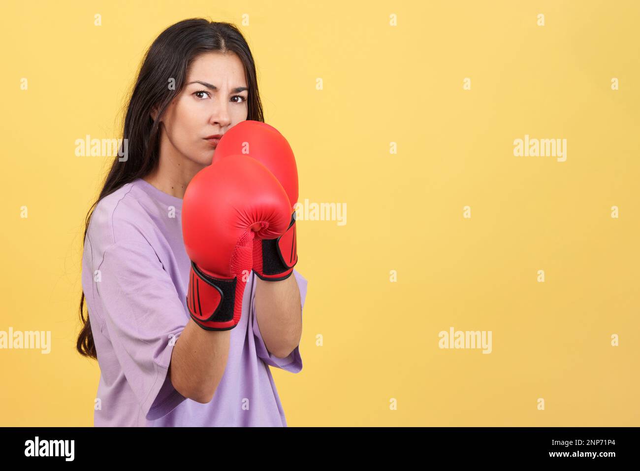 Caucasian woman with boxing gloves in fight pose Stock Photo - Alamy