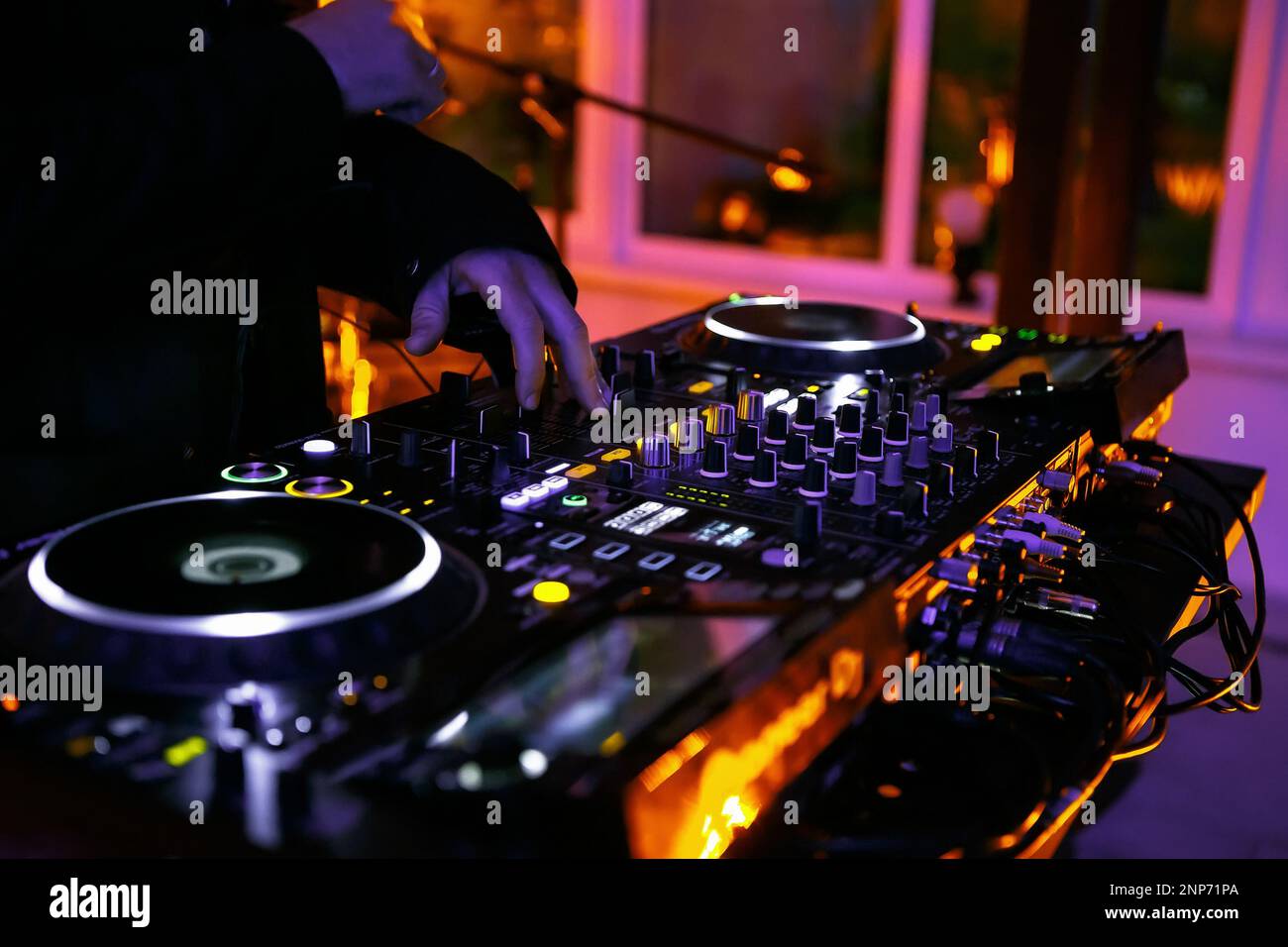 DJ girl playing music on party in night club. Hands of female disc ...