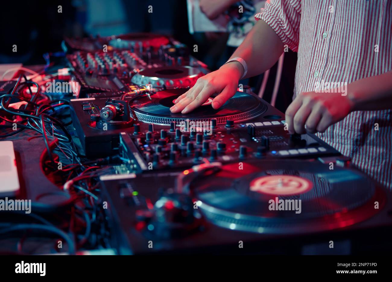 Hip hop dj scratching vinyl record on turntable. Close up photo of club ... Hip hop dj scratching vinyl record on turntable. Close up photo of club ...